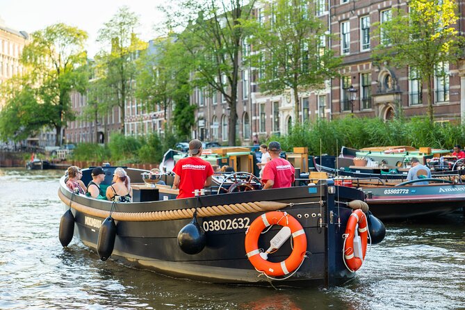 Amsterdam: Guided Open Boat Canal Cruise Including 1 Drink - The Sum Up