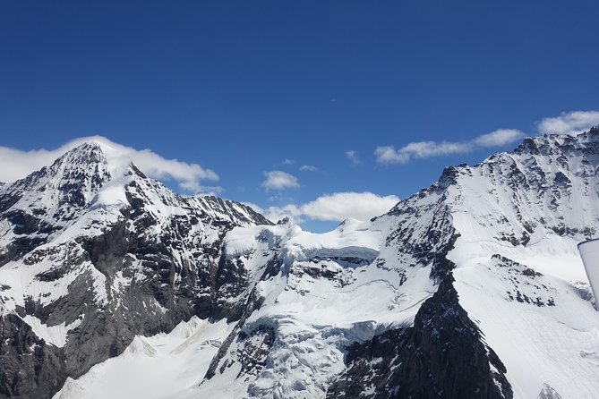 Private Swiss Alps helicopter tour over snow covered mountain peaks and glaciers